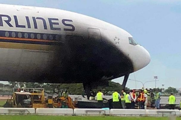 Singapore Airlines; A Boeing 777 catches fire while tow trucks towing ...